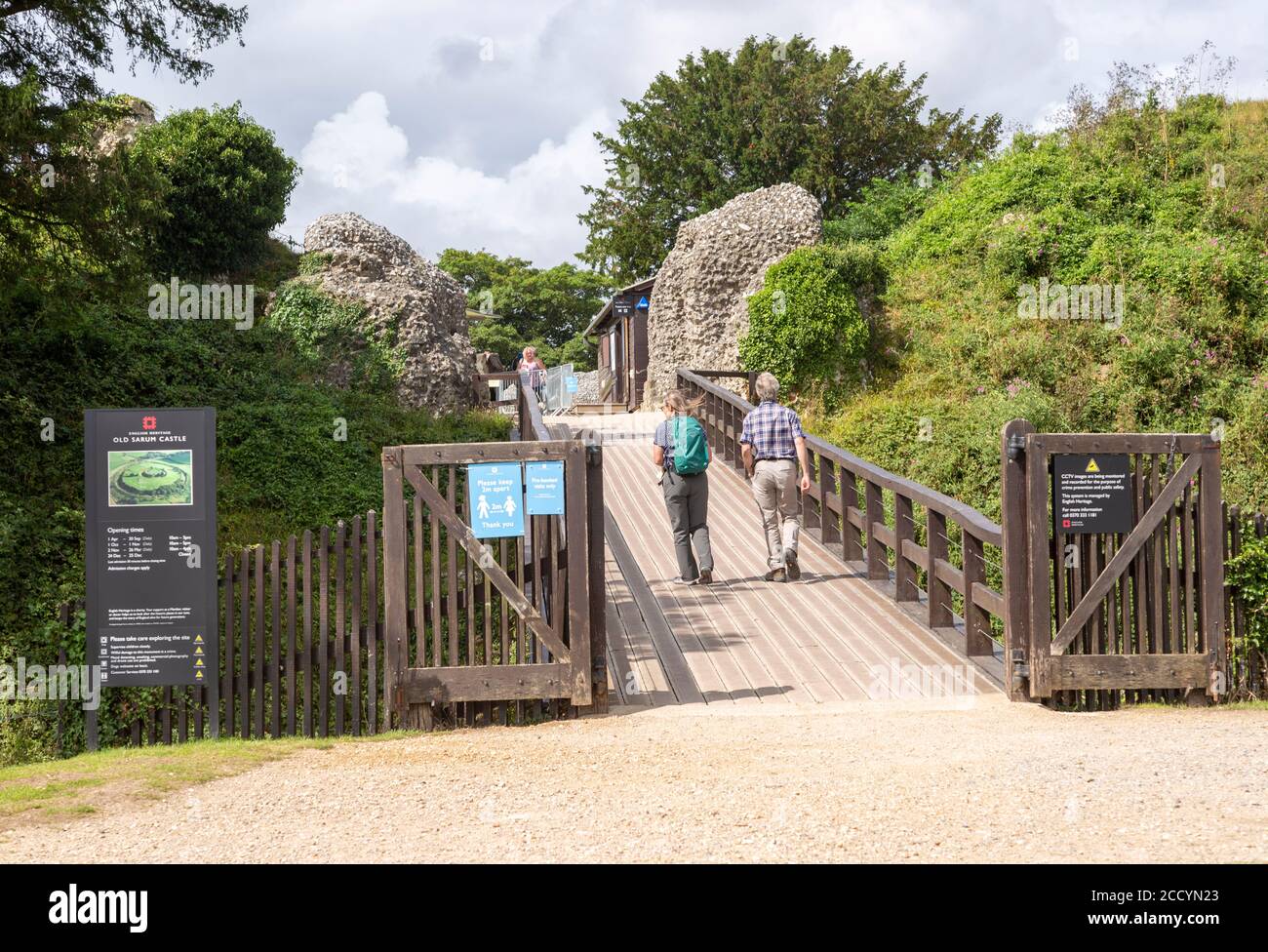 People walk over bridge entrance to Old Sarum castle, Salisbury ...
