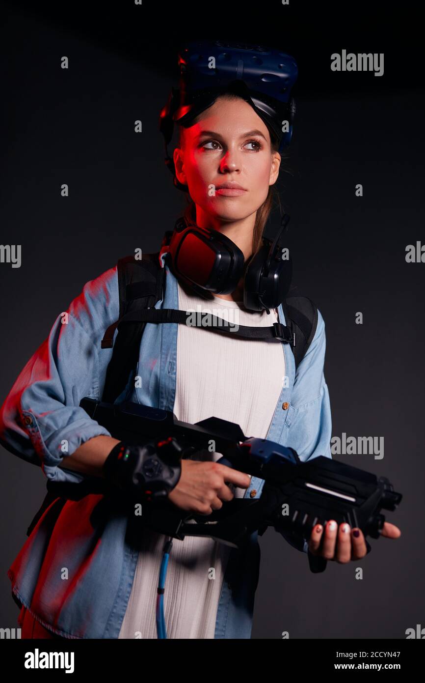 Portrait of beautiful woman with virtual reality shooter isolated on ...