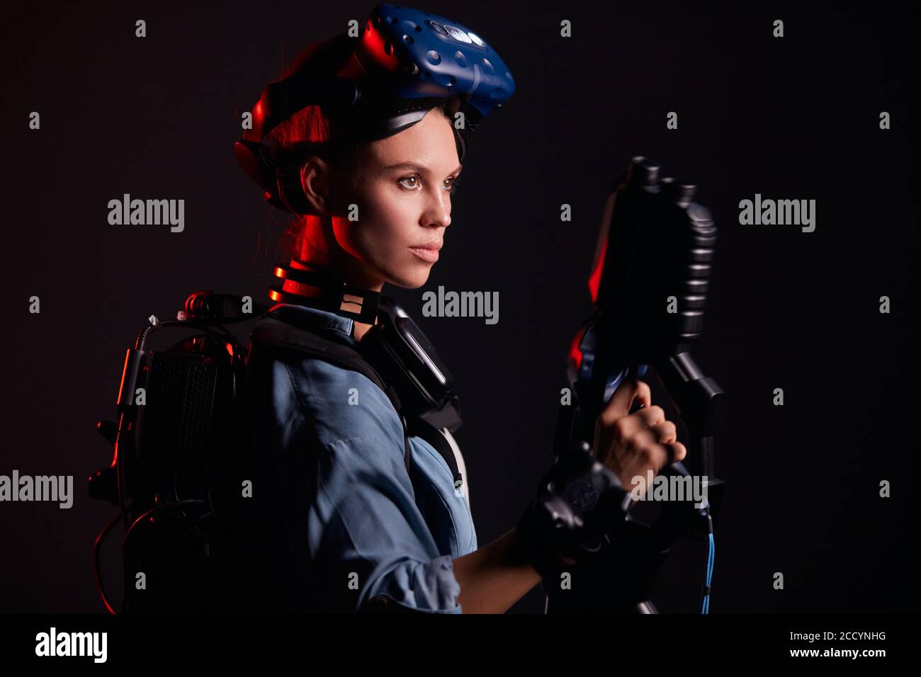 VR female gamer use modern technology, virtual reality game with guns ...