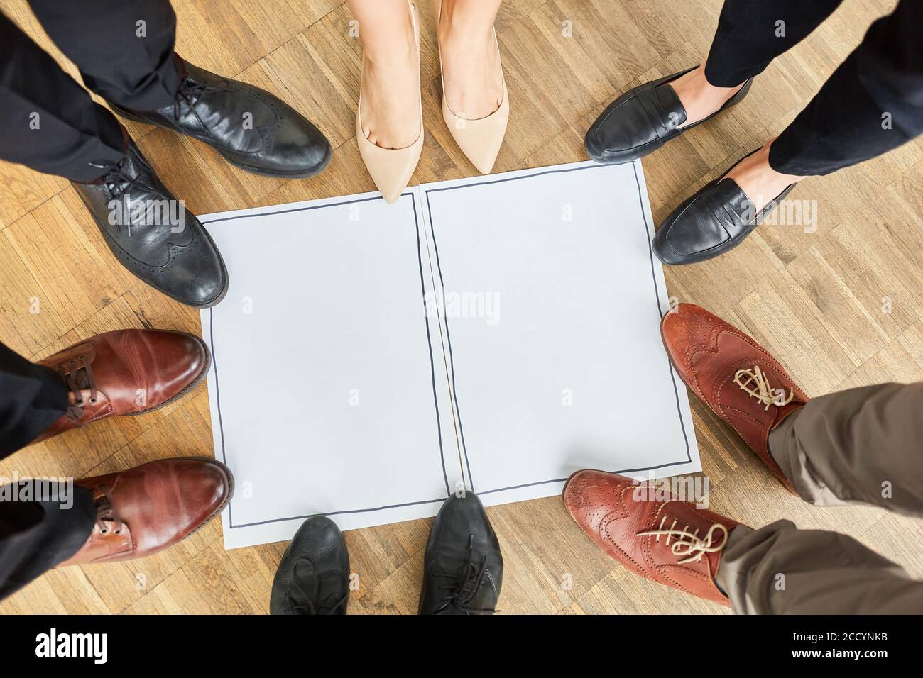 Feet and shoes of group of business people at a meeting in the office ...