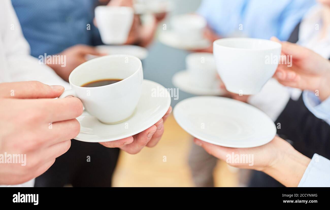 Business colleagues drinking a cup of coffee during a break in the ...