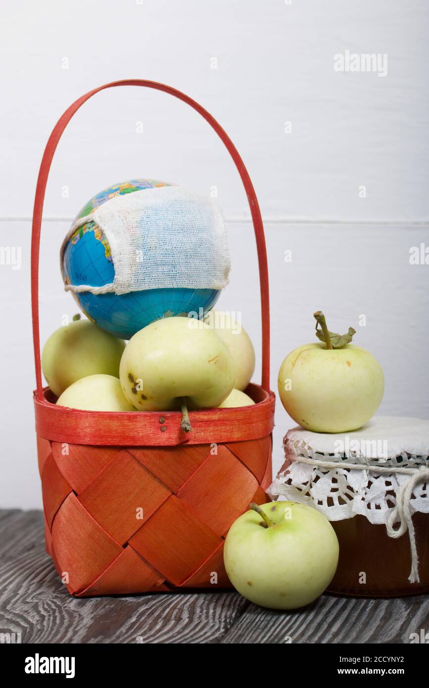 Apples in a red wicker basket. Jam in jars and apples nearby. Fruit ...