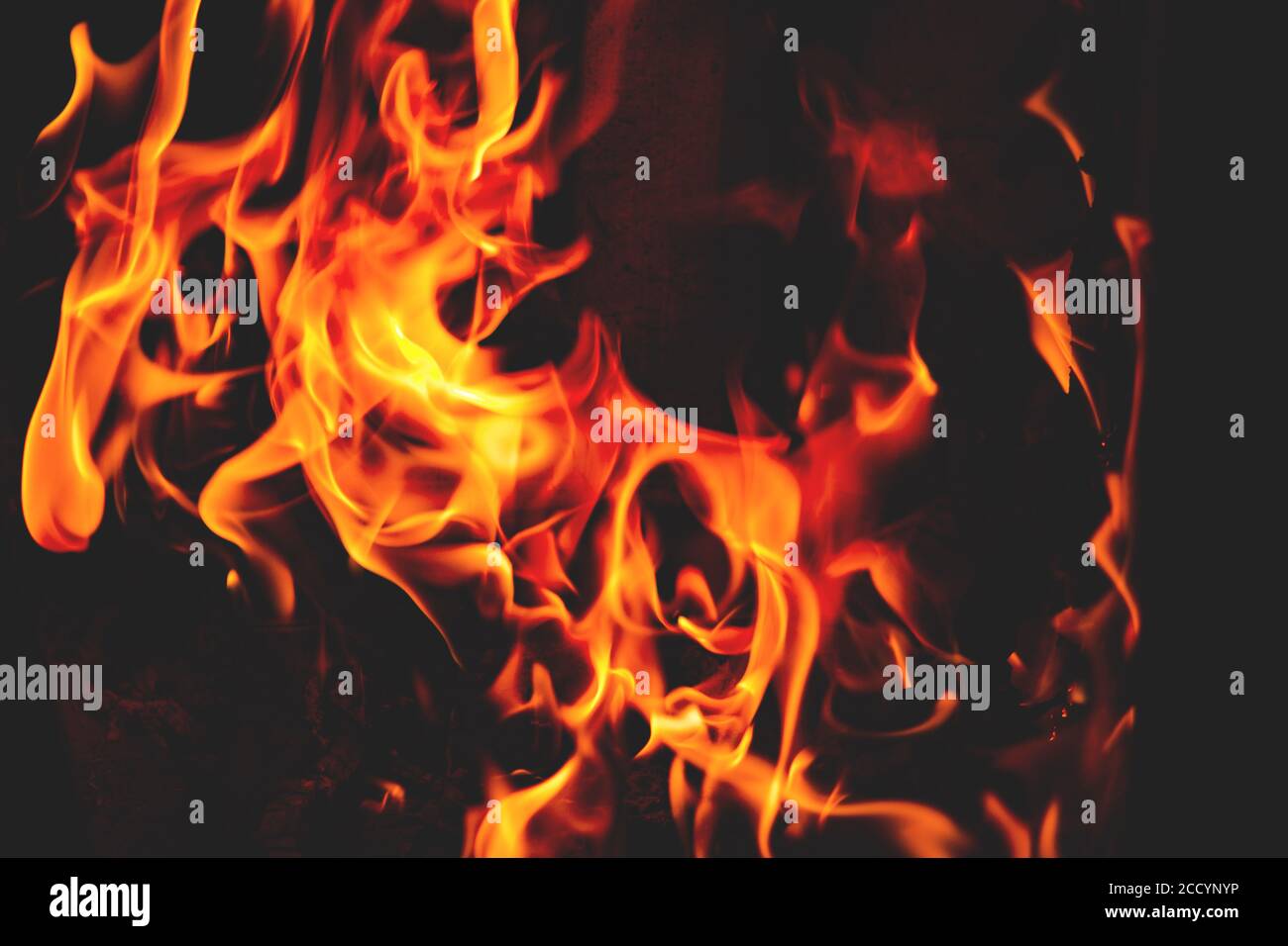 Closeup shot of blazing fire flame isolated on black background Stock ...