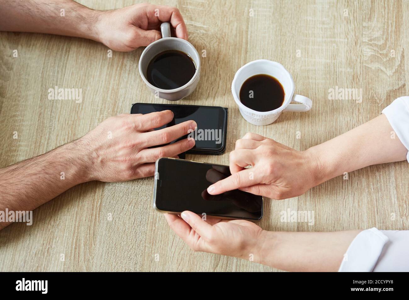 People drink coffee and use the smartphone app on the touchscreen Stock ...