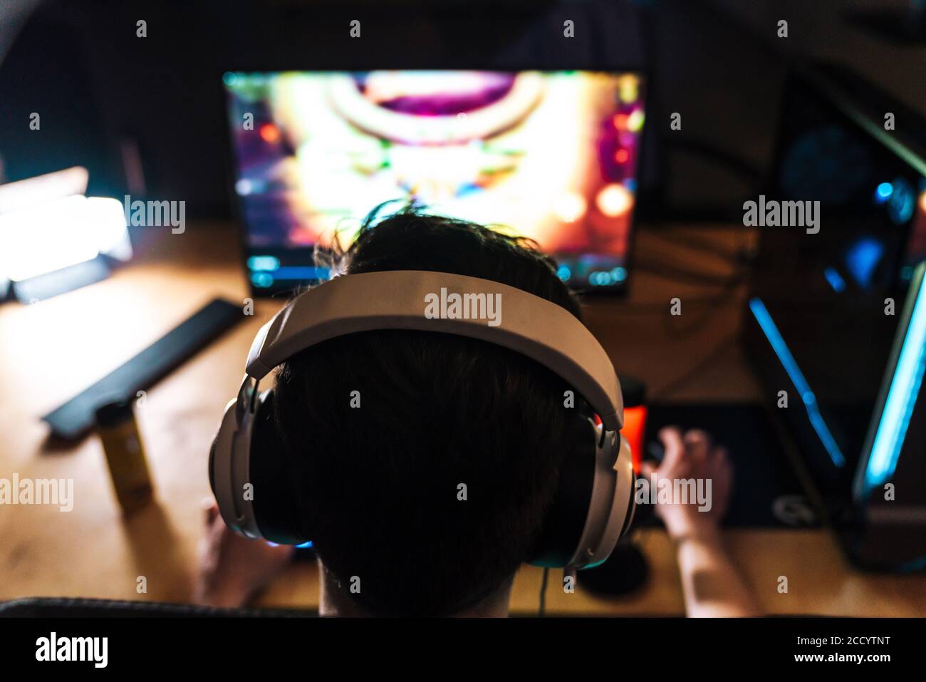 Image of focused brunette man in headphones playing video game on ...