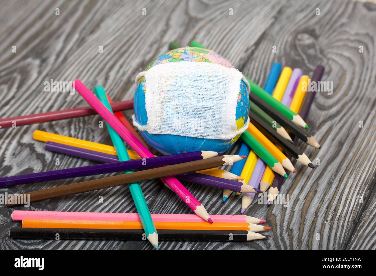 Colour pencils. Globe with medical mask. Academic year during the ...