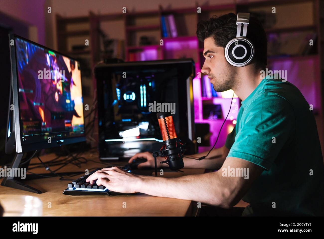 Image of caucasian focused man in headphones playing video game on ...