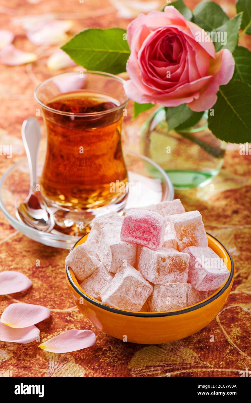Bowl with diced Turkish delight, tea and rose Stock Photo - Alamy
