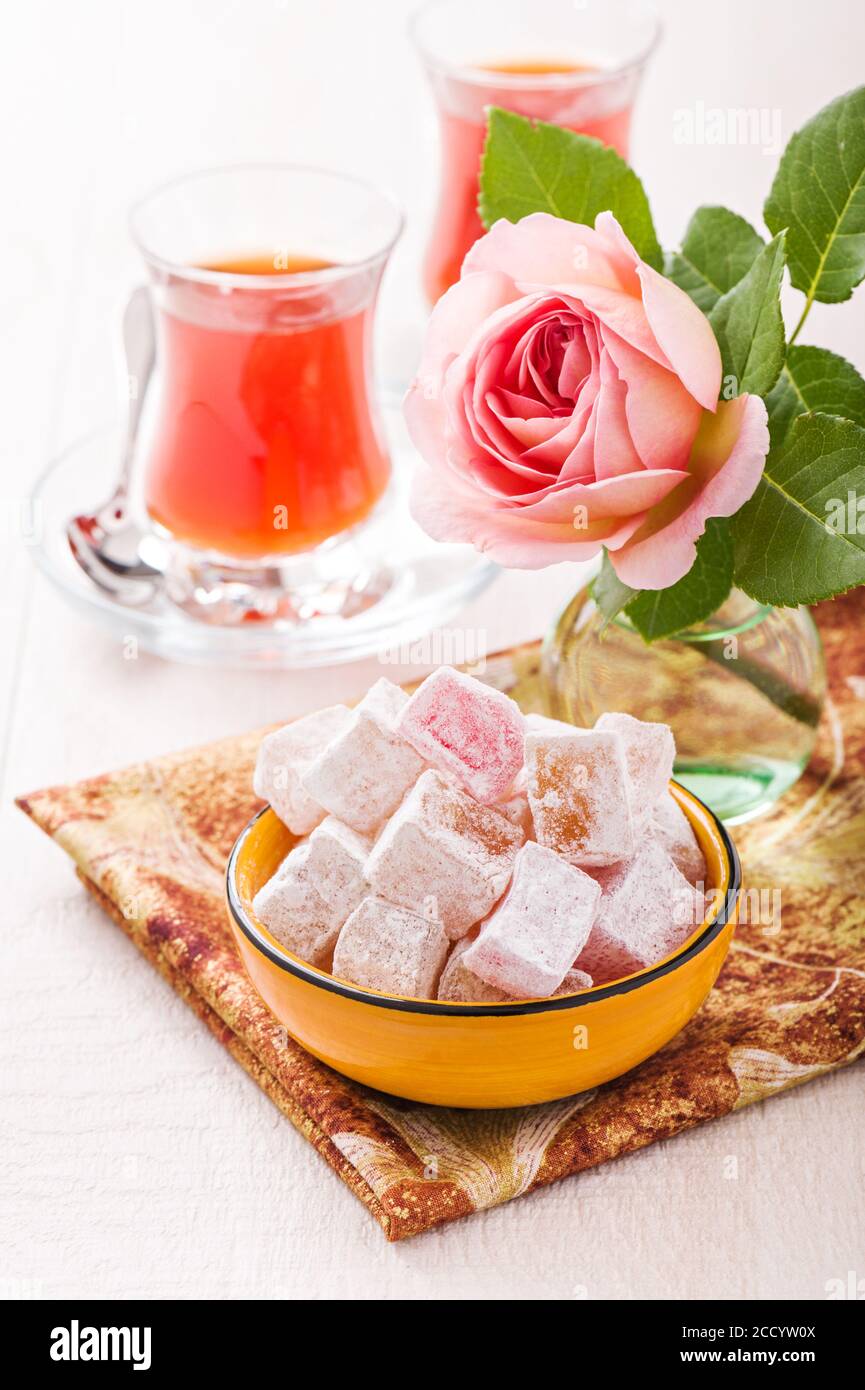 Bowl with diced Turkish delight, tea and rose Stock Photo - Alamy