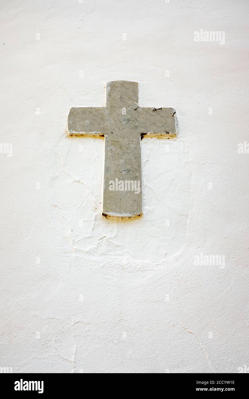 An old religious marble cross embedded in a white wall Stock Photo - Alamy
