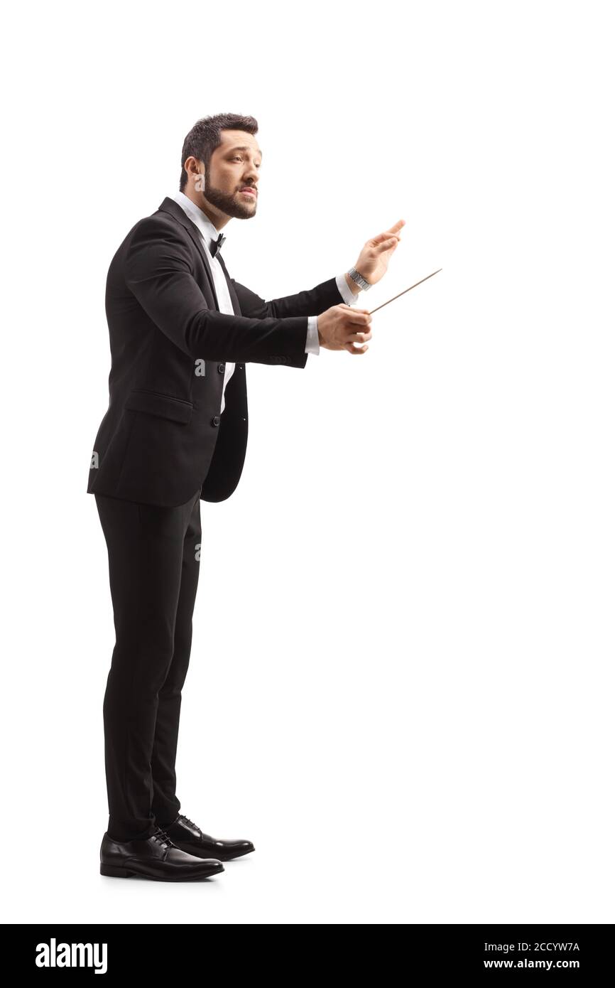 Full length profile shot of a music conductor directing a performance ...