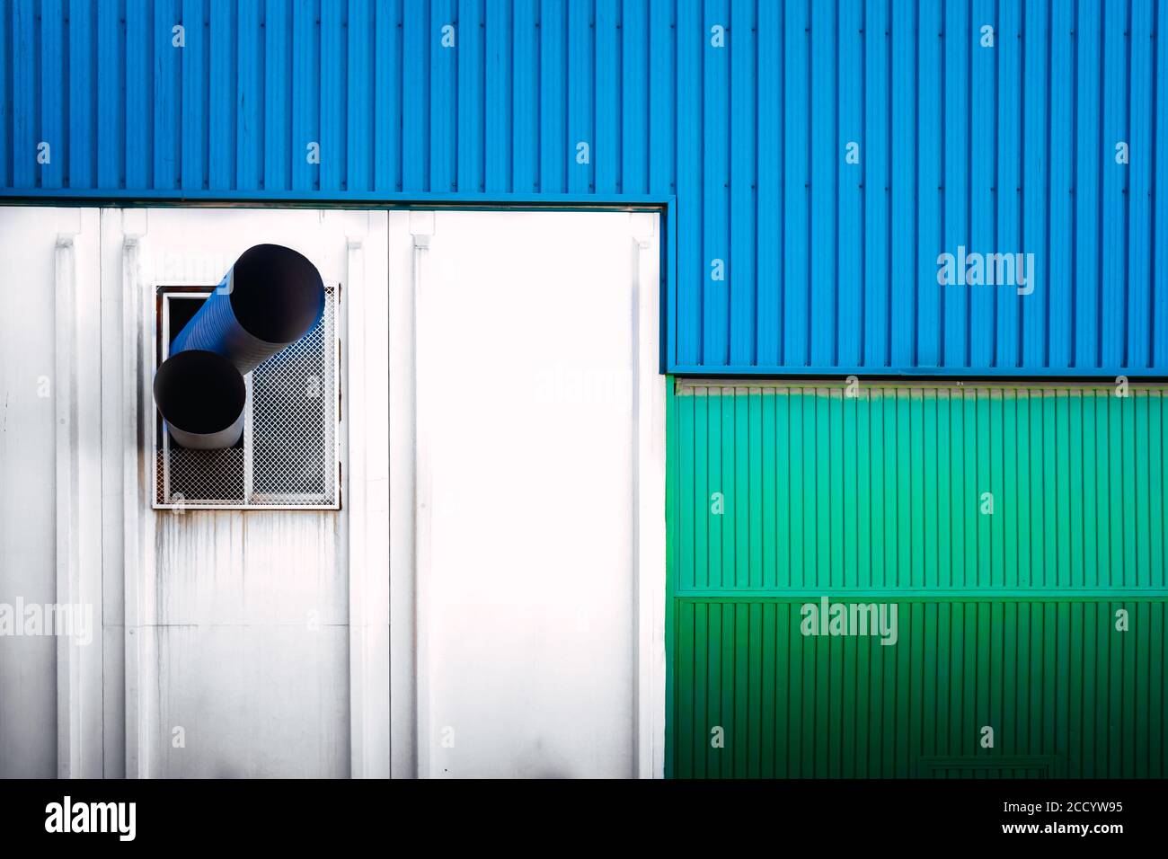 Exterior part of an industrial building with two ventilation pipes ...