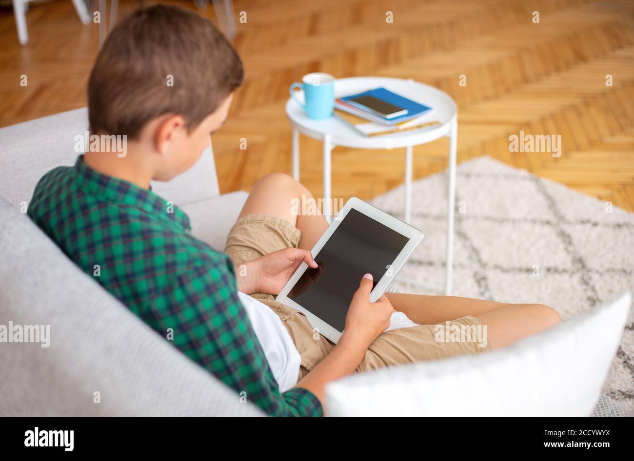 Teenager holding digital tablet with empty screen, home interior Stock ...