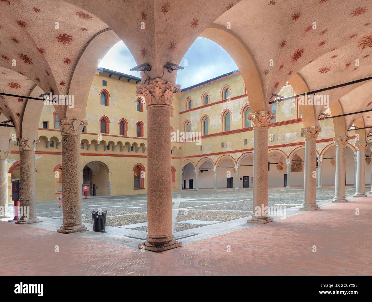 rectangular courtyard of an elegant stately home with arches decorated ...