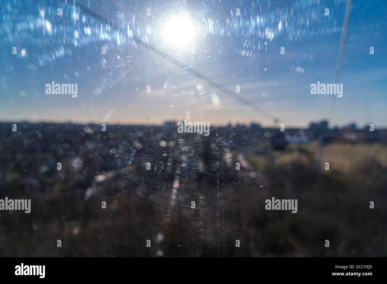 Blurred image of the sun through a scratched window pane for ...
