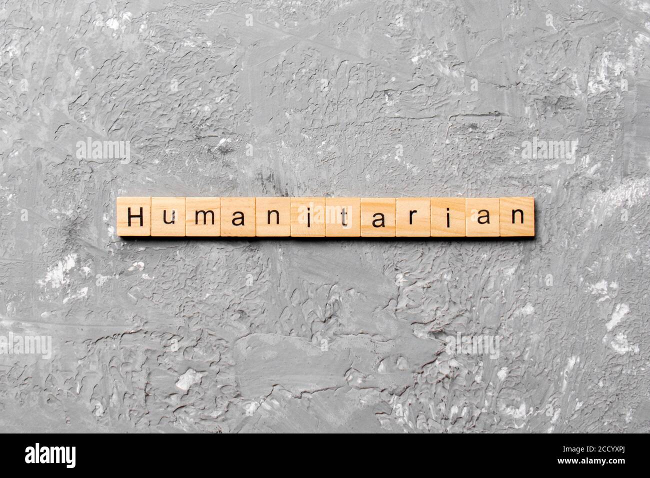 humanitarian word written on wood block. humanitarian text on table ...