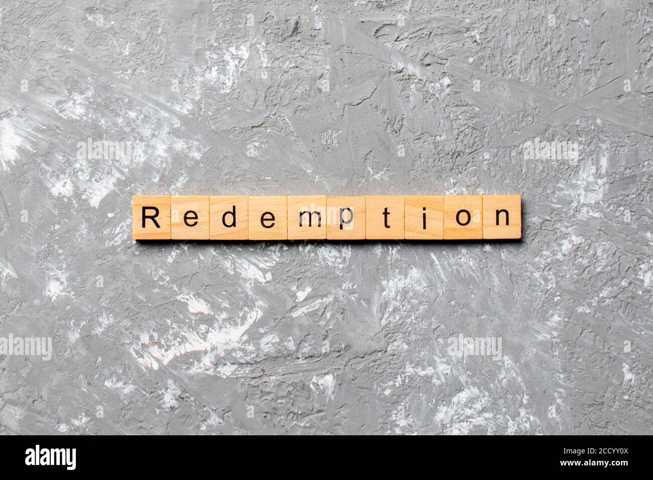 redemption word written on wood block. redemption text on cement table ...