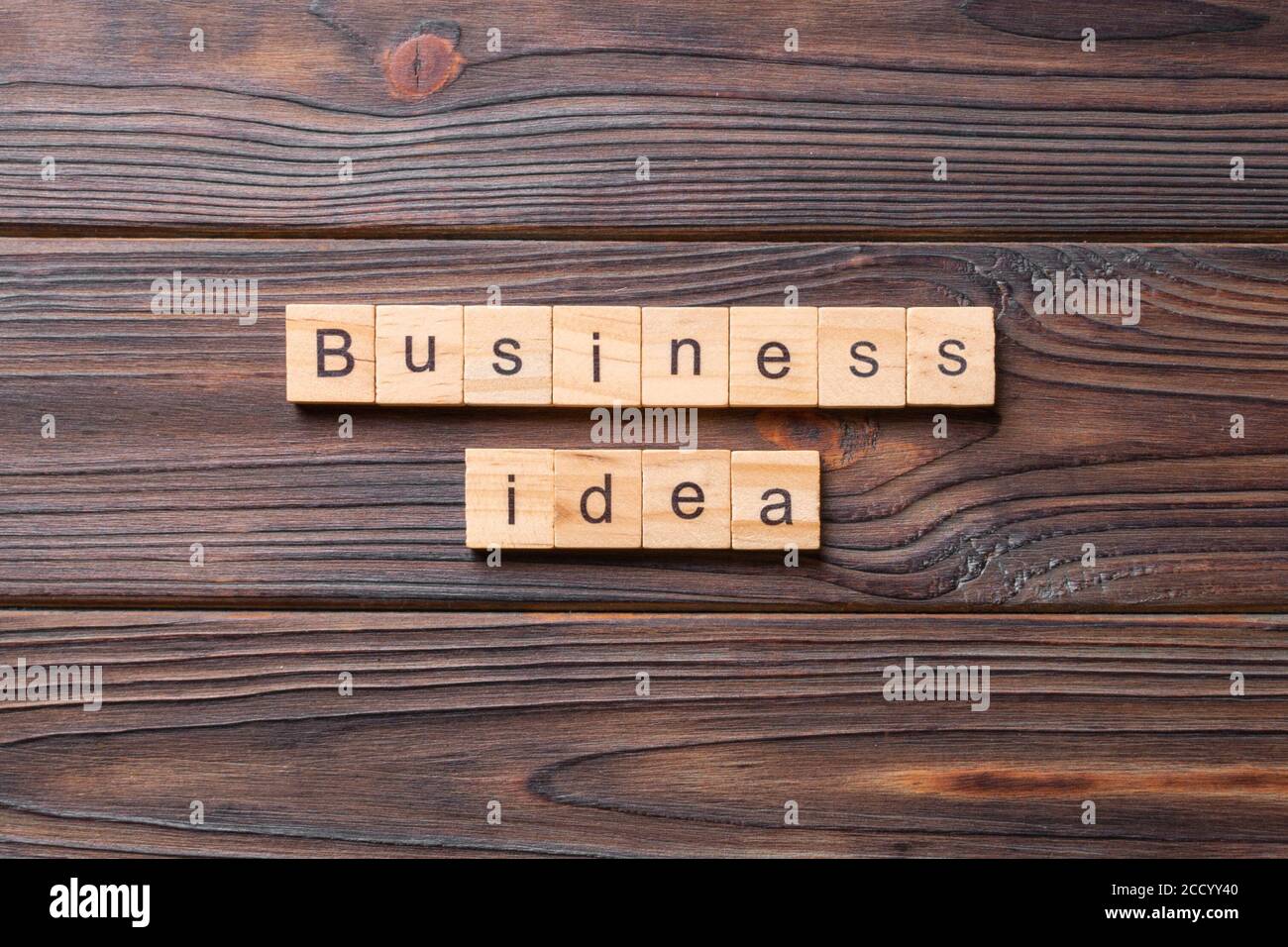 business idea word written on wood block. business idea text on cement ...