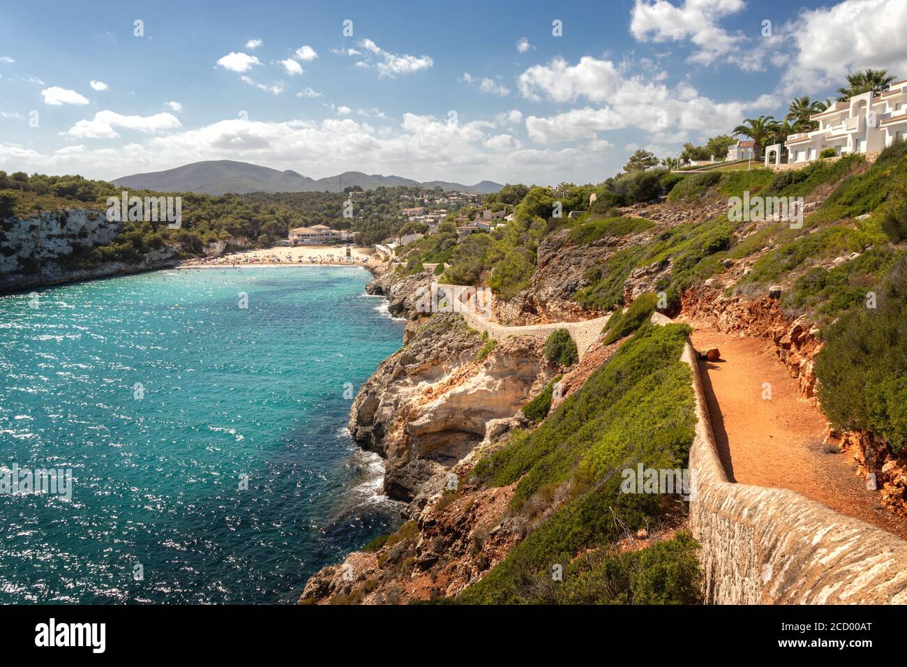 Typical Spanish beach scene with pathway leading to beach surrounded by ...