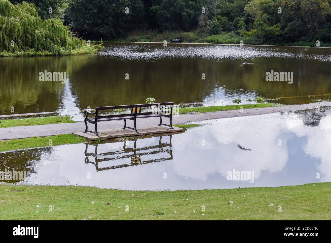 Flood water overflows from a lake during flooding after heavy rain and ...