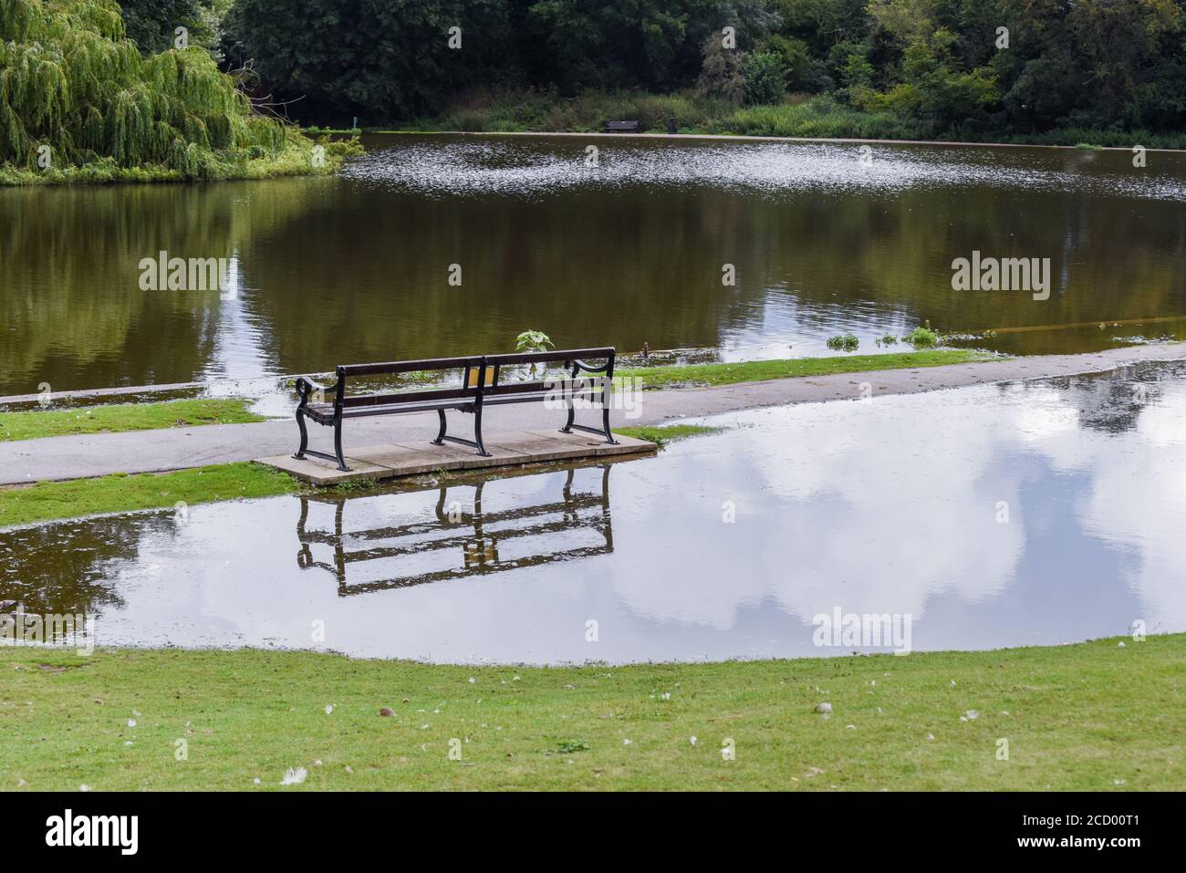 Flood water overflows from a lake during flooding after heavy rain and ...