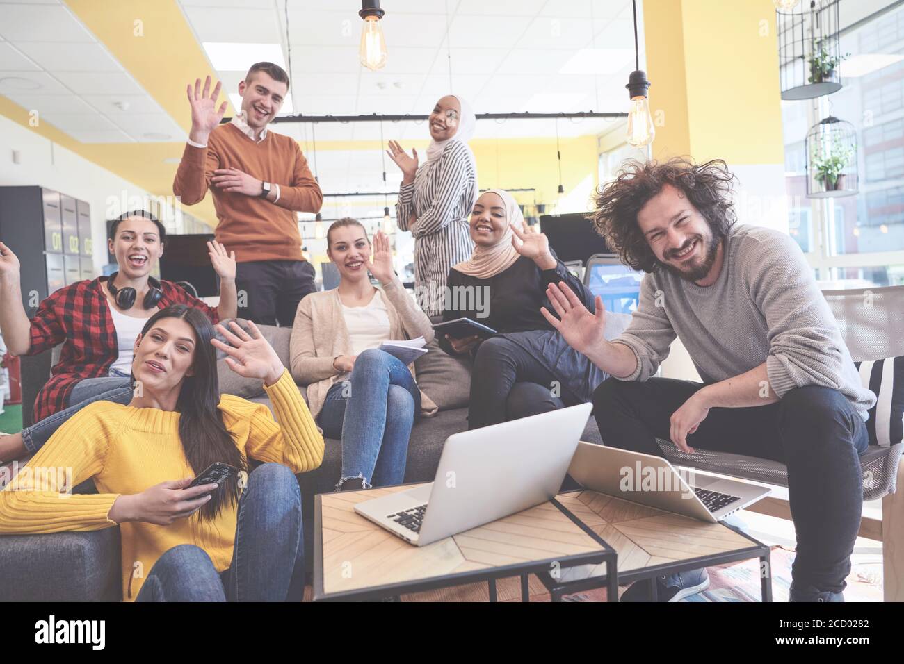 business team celebrating and have fun at modern coworking open space ...