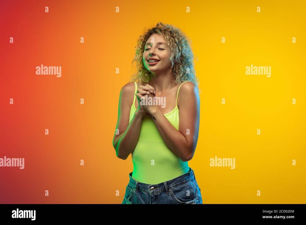 Praying hopeful. Caucasian young woman's portrait isolated on gradient ...
