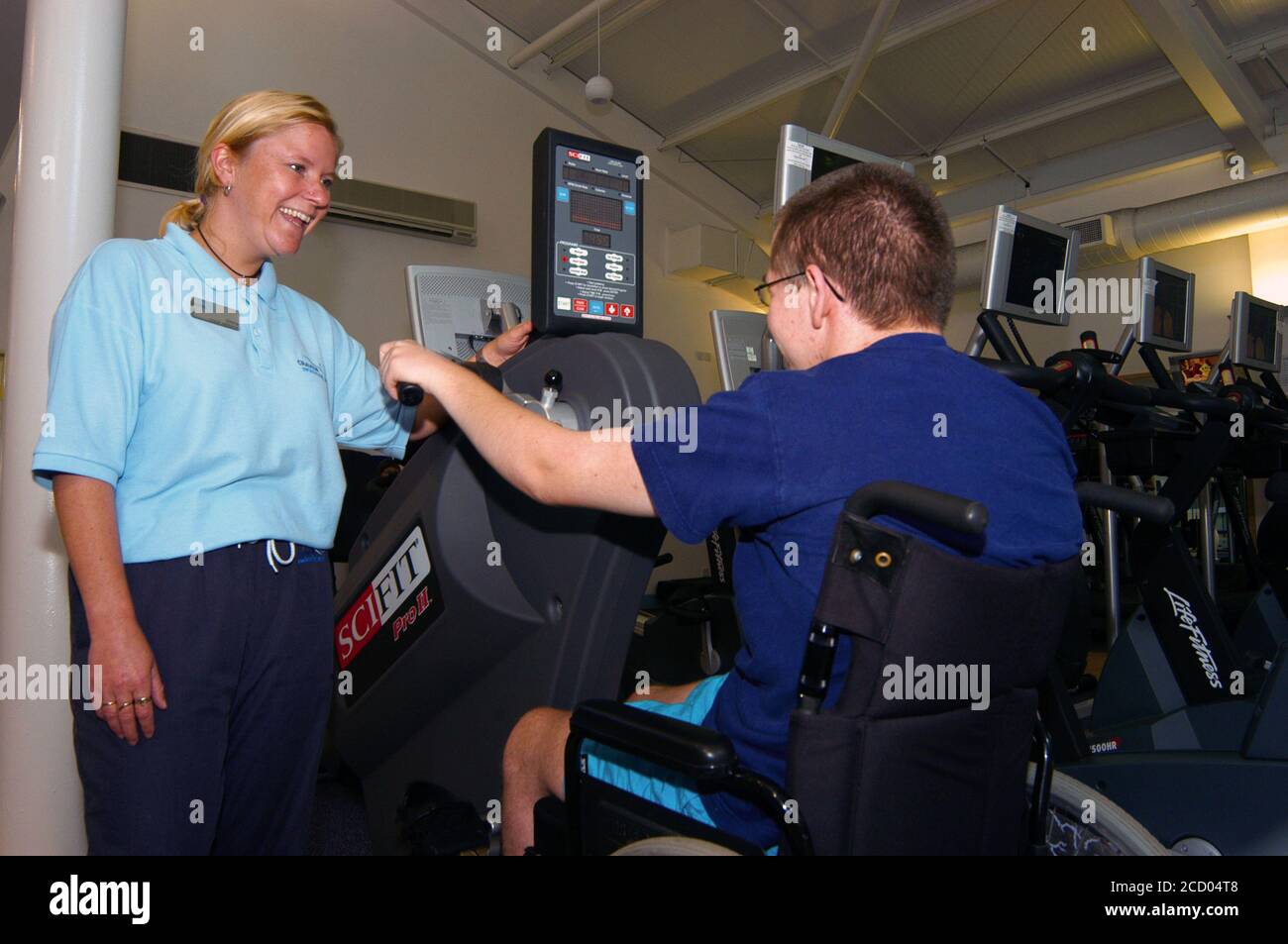 Disabled man in wheelchair using new gym facilities especially adapted ...