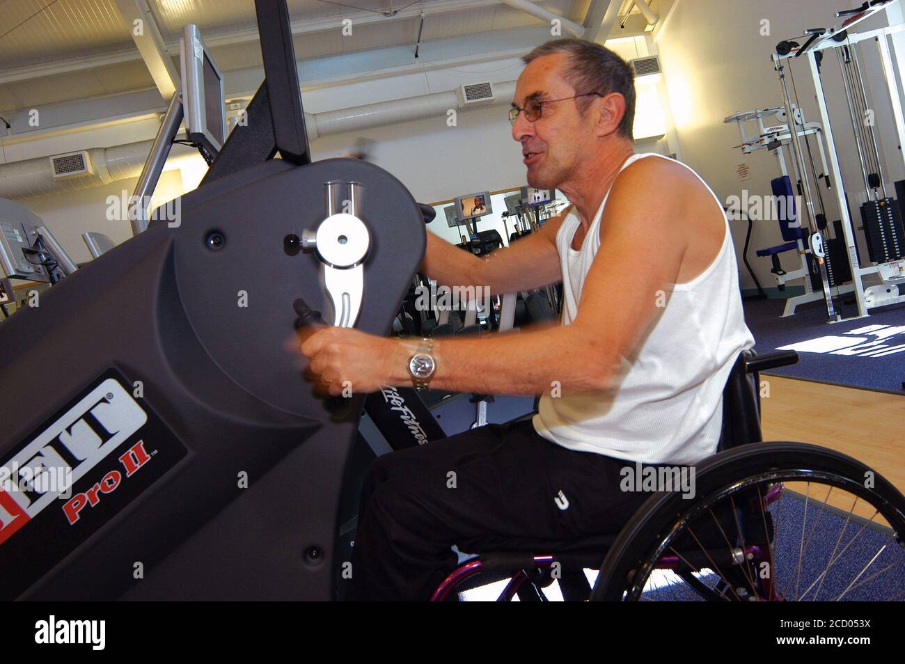 Disabled man in wheelchair using new gym facilities especially adapted ...