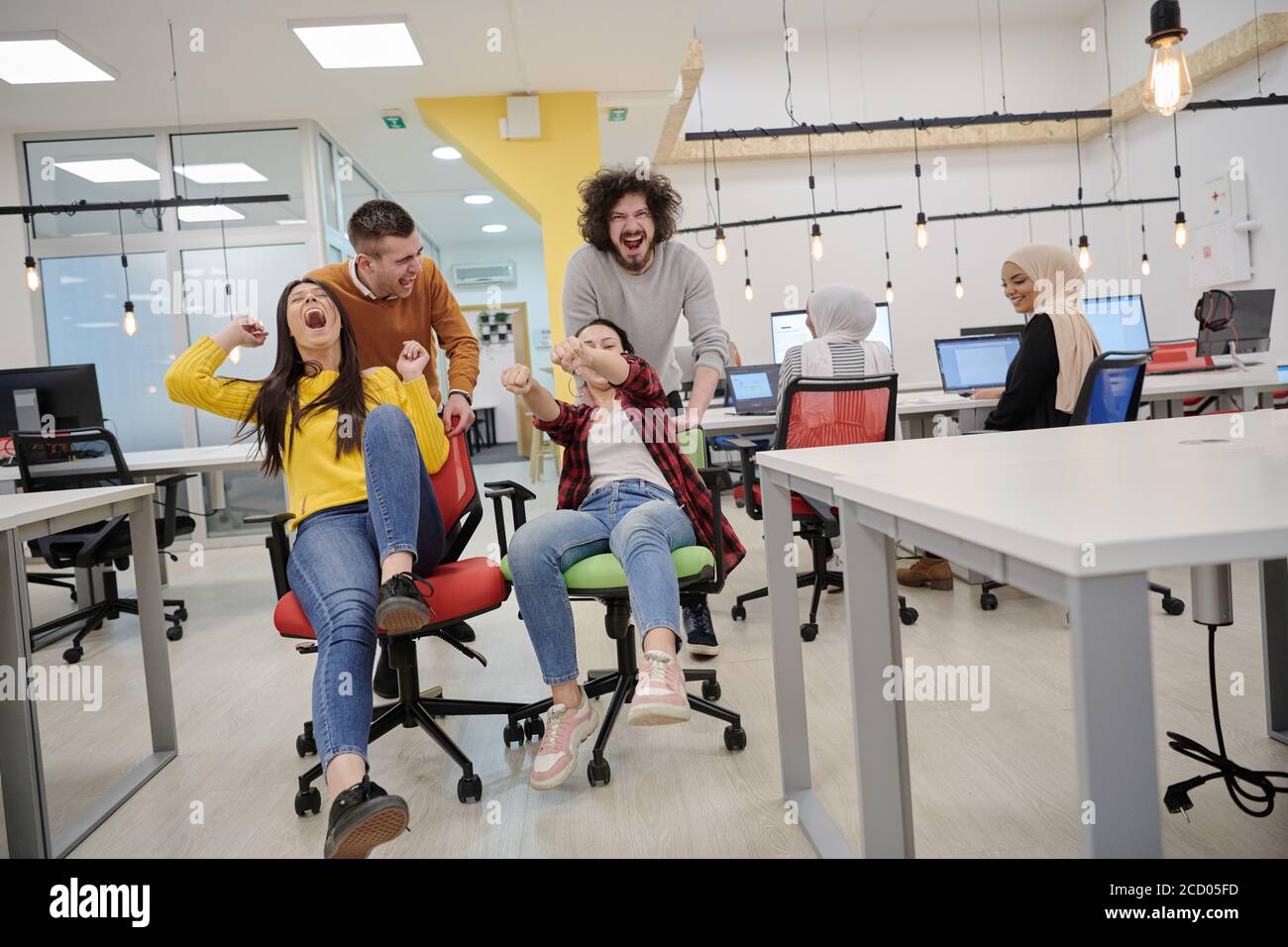 business people having fun while racing on office chairs Stock Photo ...