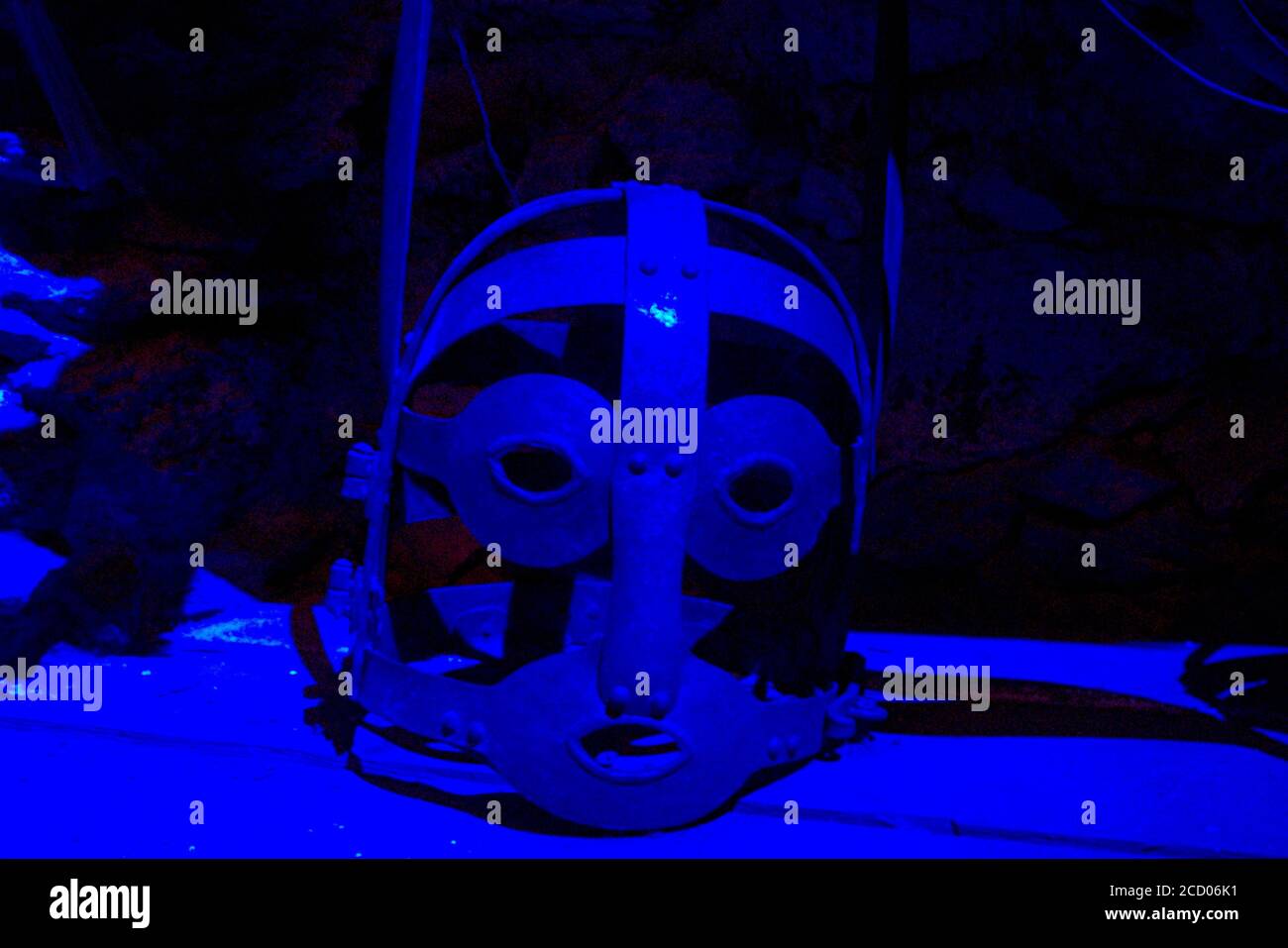 Unusual Medieval metal helmet in a creepy blue lighting Stock Photo - Alamy