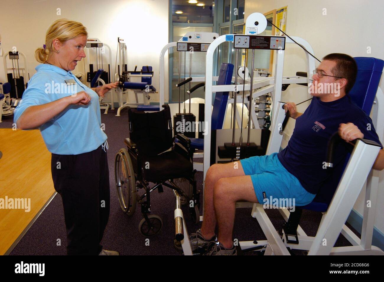 Disabled man in wheelchair using new gym facilities especially adapted ...