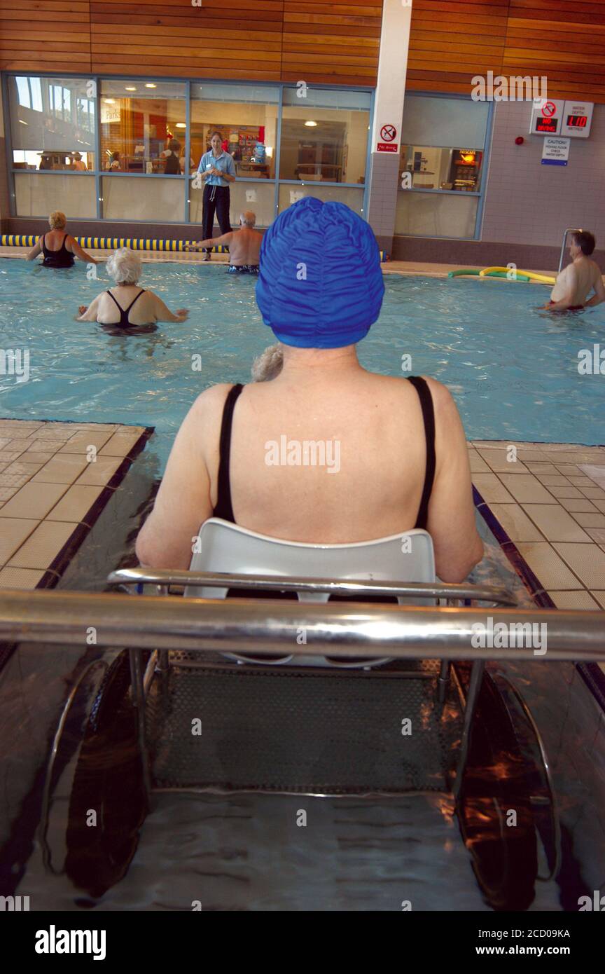 Disabled woman in wheelchair using new facilities in Council swimming ...