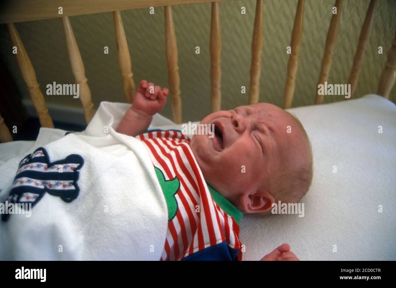 Crying in cot hi-res stock photography and images - Alamy