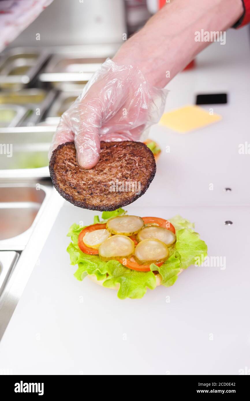Hands preparing meat sandwich hi-res stock photography and images - Alamy