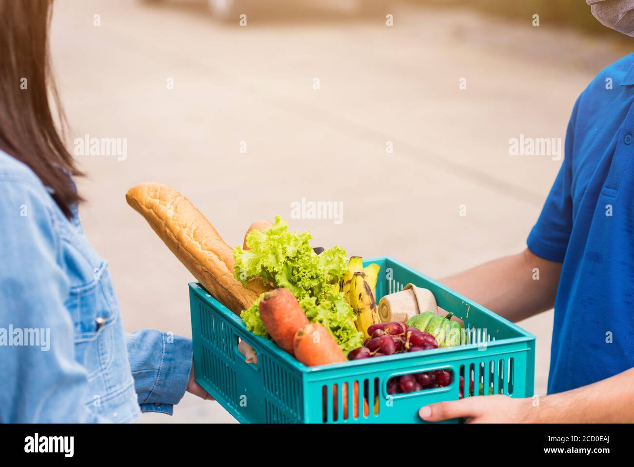 Asian young delivery man wear face mask making grocery fast service ...