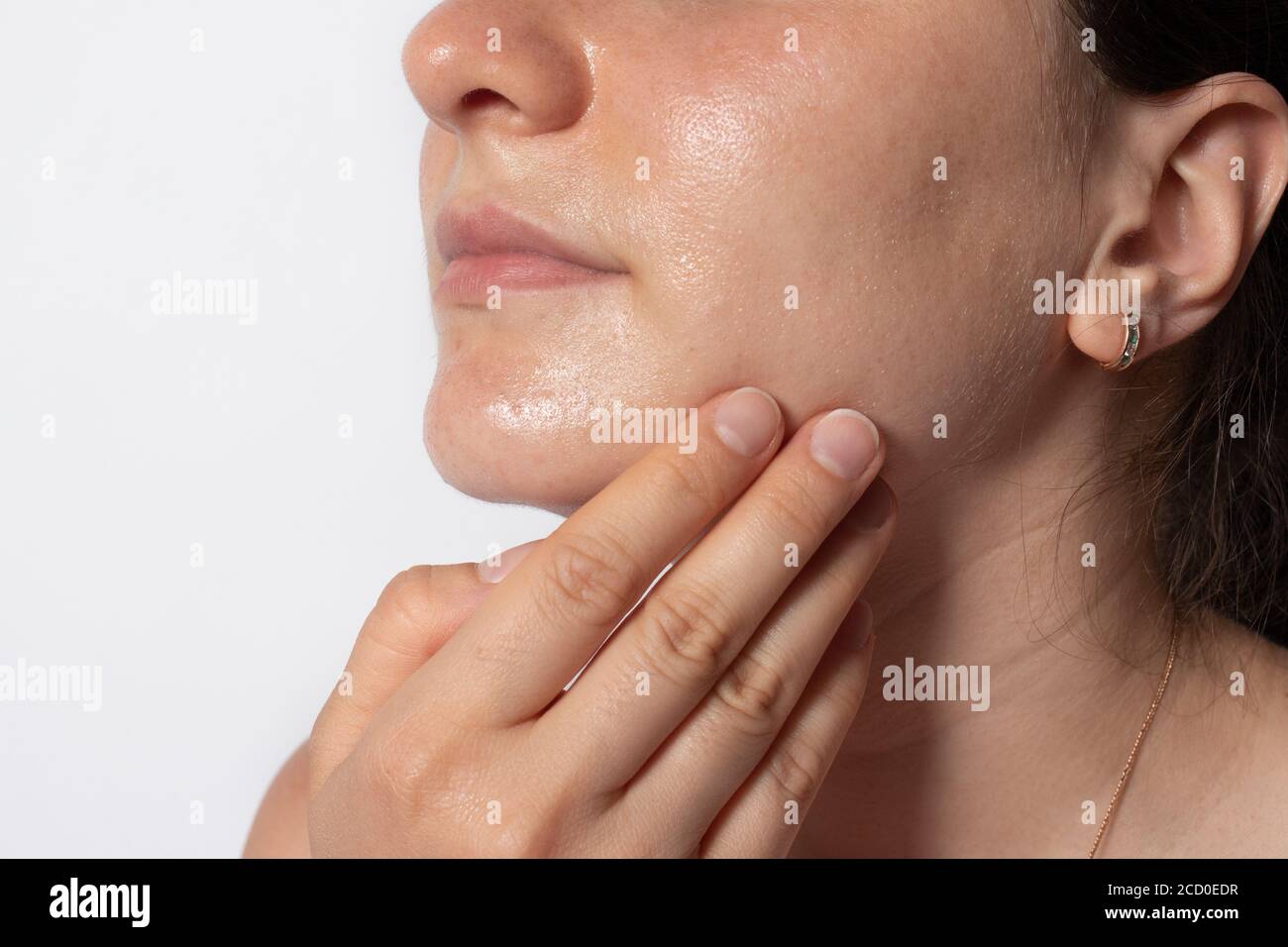 The woman puts oil on the skin and massages the face. Hydrophilic oil ...