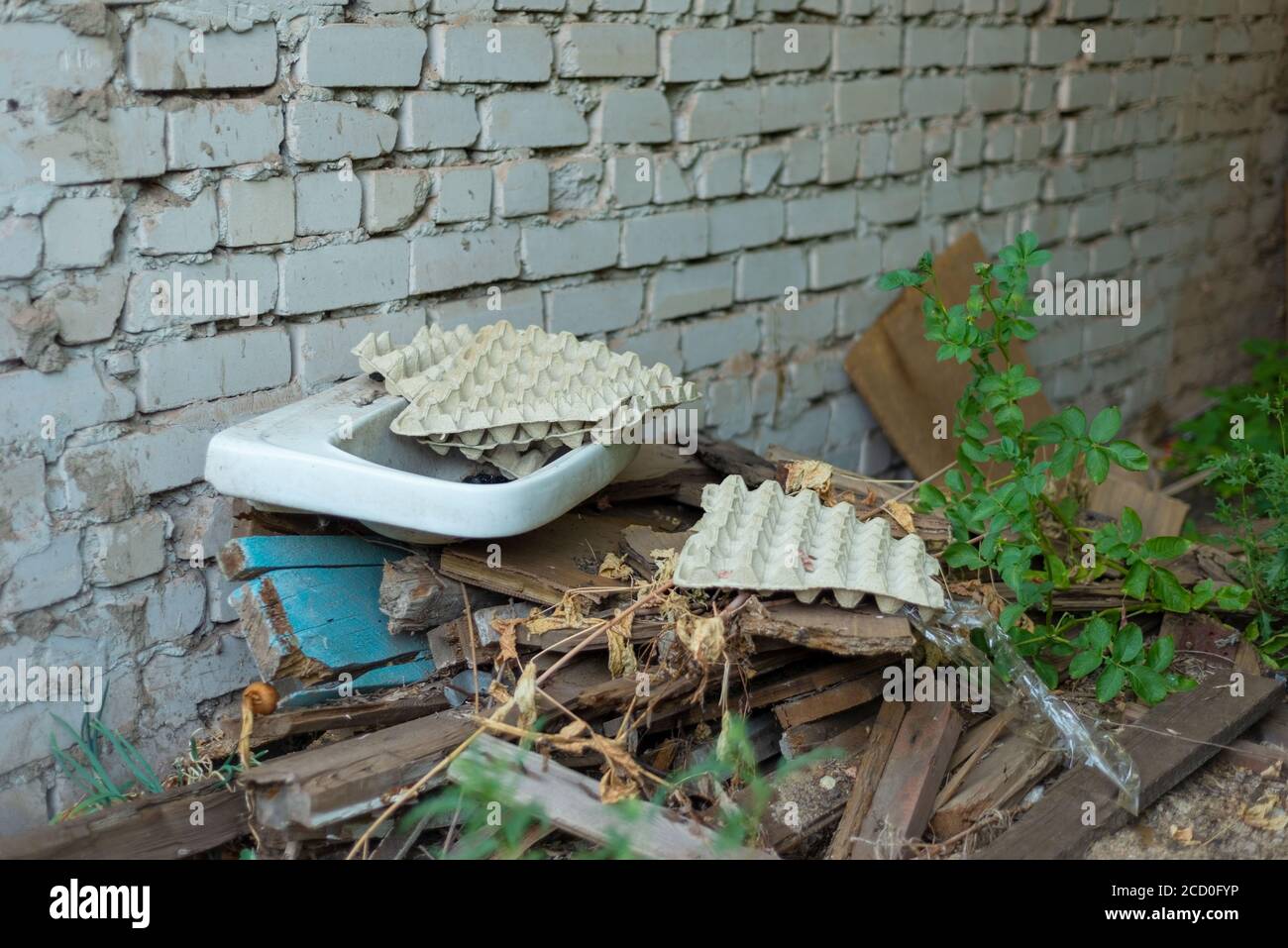 old washbasin on an abandoned house, dump, against the background of a ...