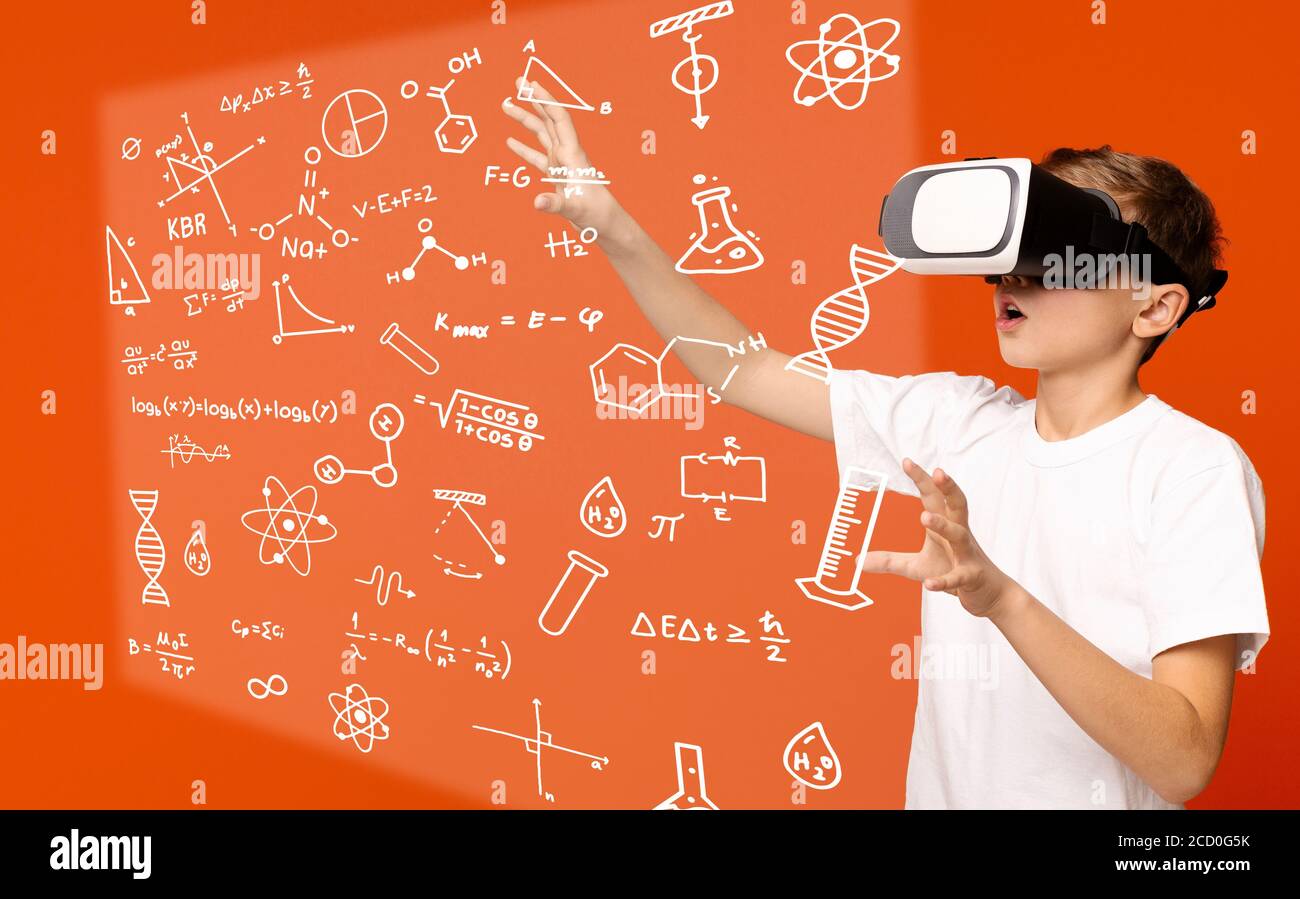 Teenager using VR glasses for studying, orange background Stock Photo ...