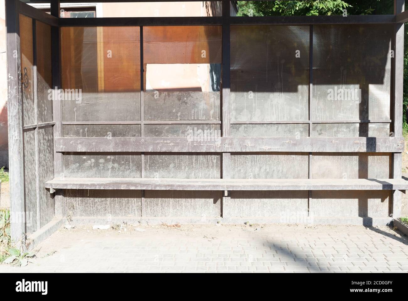a dirty bus stop smeared with whitewash stains. Deserted station ...