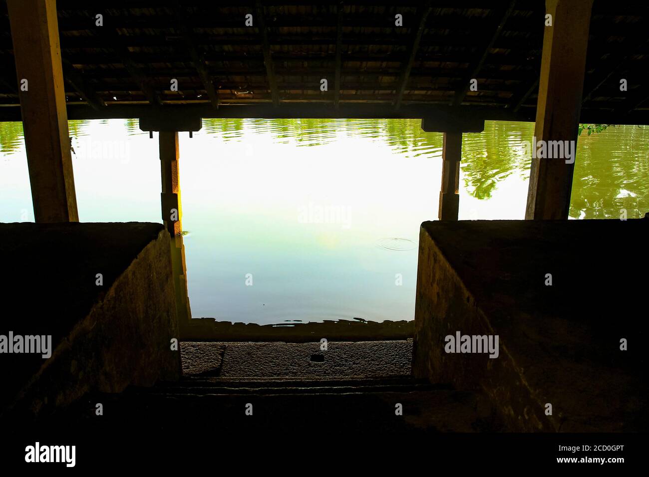kerala temple statues, temple pond Stock Photo - Alamy