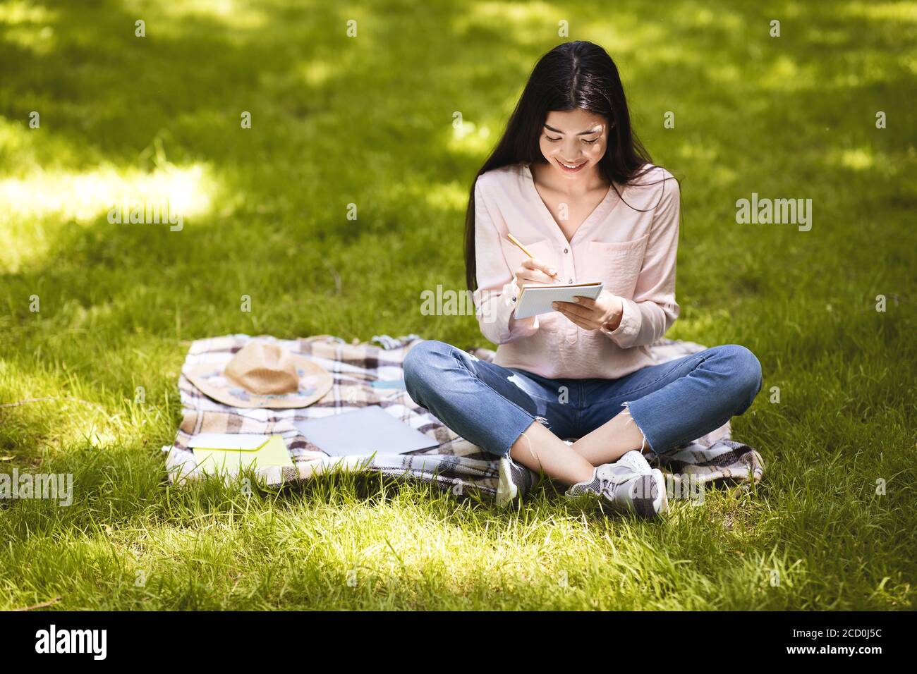 Girl writing in notepad hi-res stock photography and images - Alamy