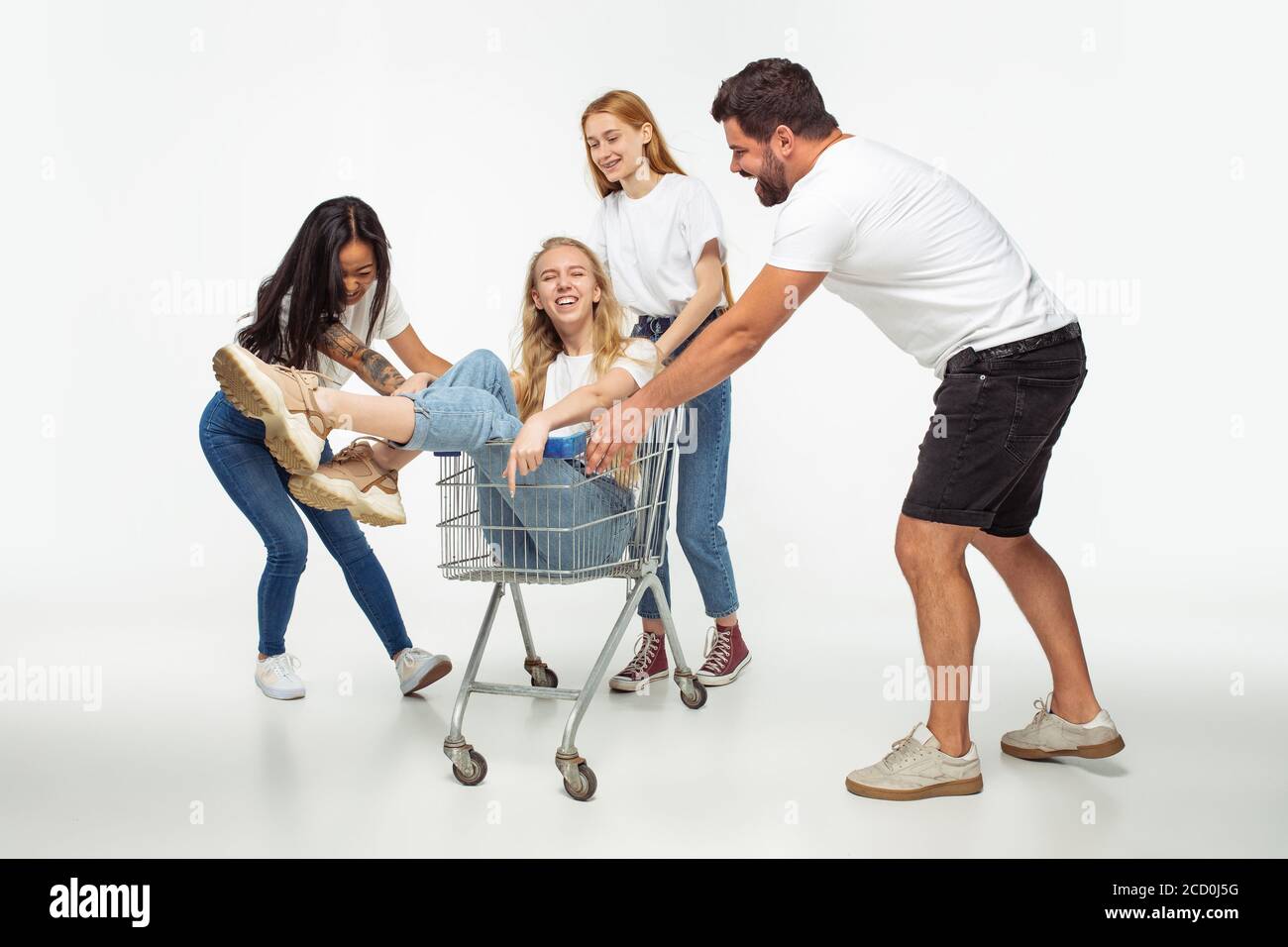 Group of adorable multiethnic friends having fun isolated over white ...