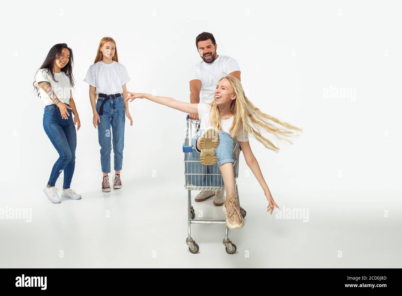 Group of adorable multiethnic friends having fun isolated over white ...