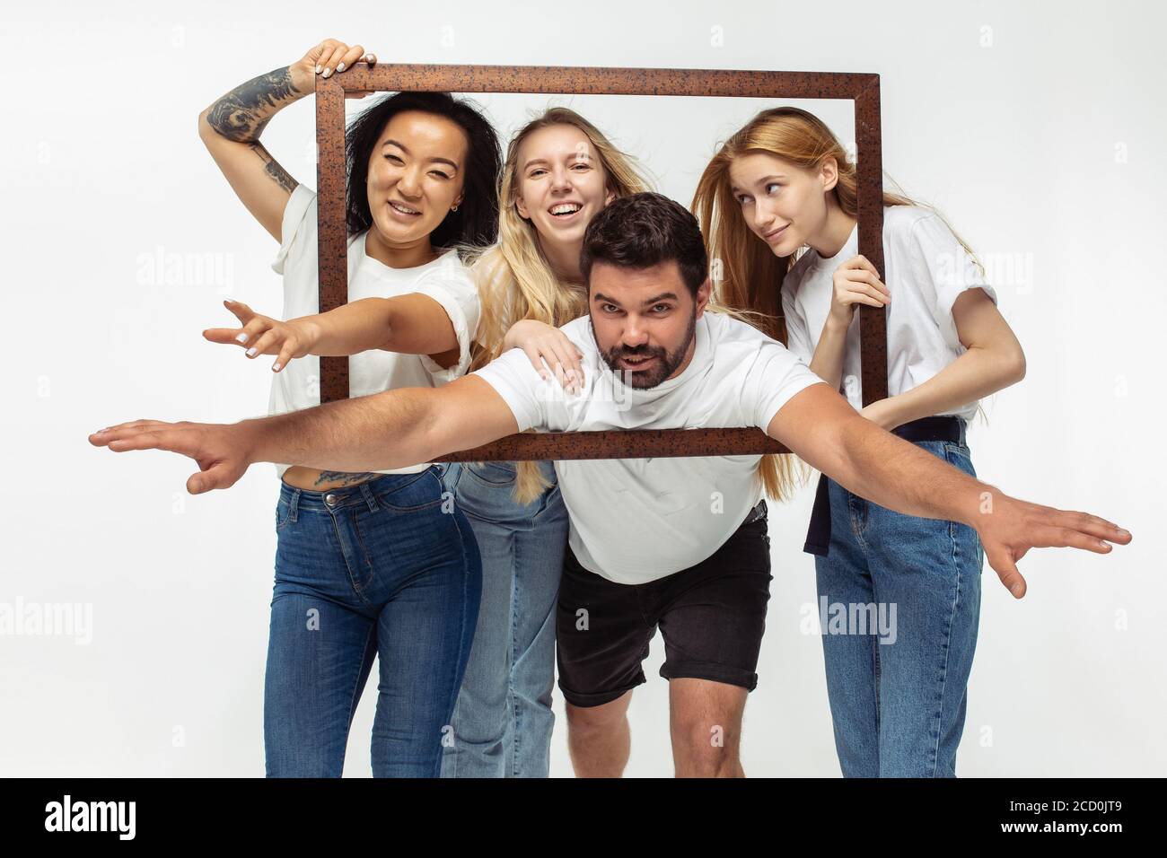 Photo frame. Group of adorable multiethnic friends having fun on white ...
