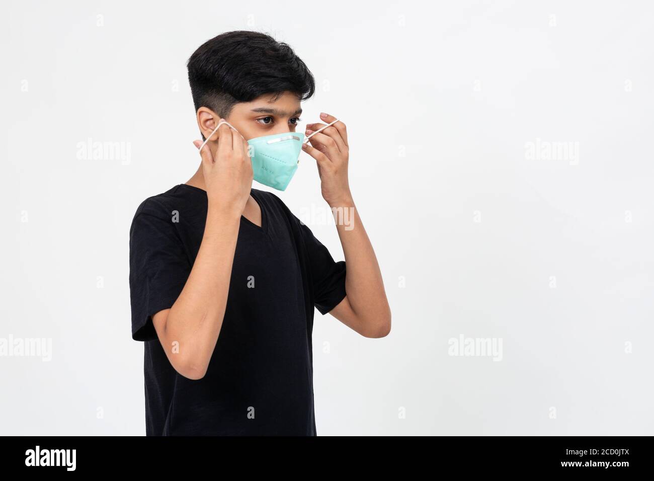 Young Indian boy wears face mask for protection against Covid-19. Cute ...