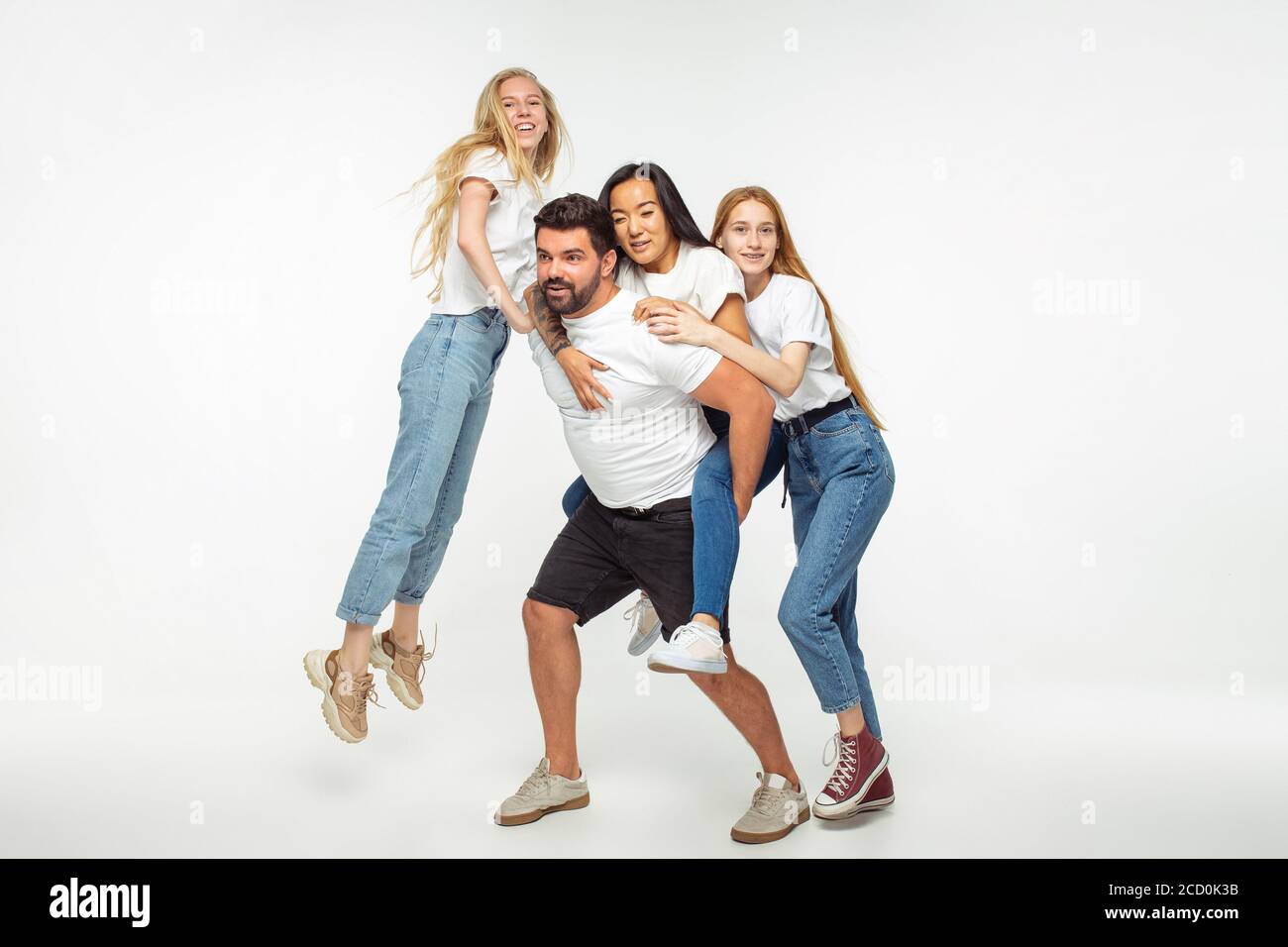 Group of adorable multiethnic friends having fun isolated over white ...