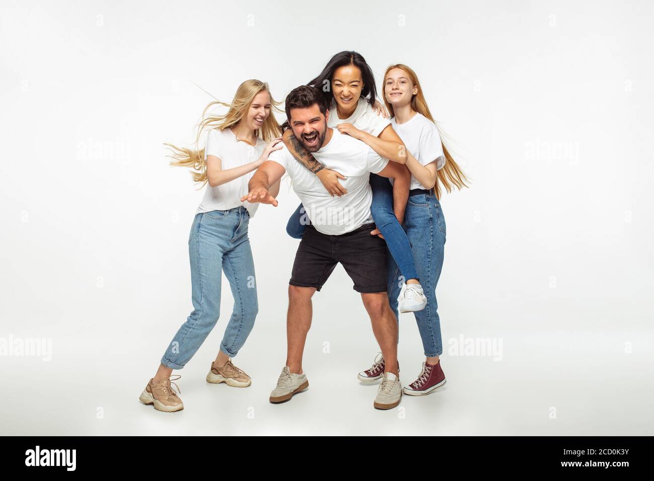 Group of adorable multiethnic friends having fun isolated over white ...