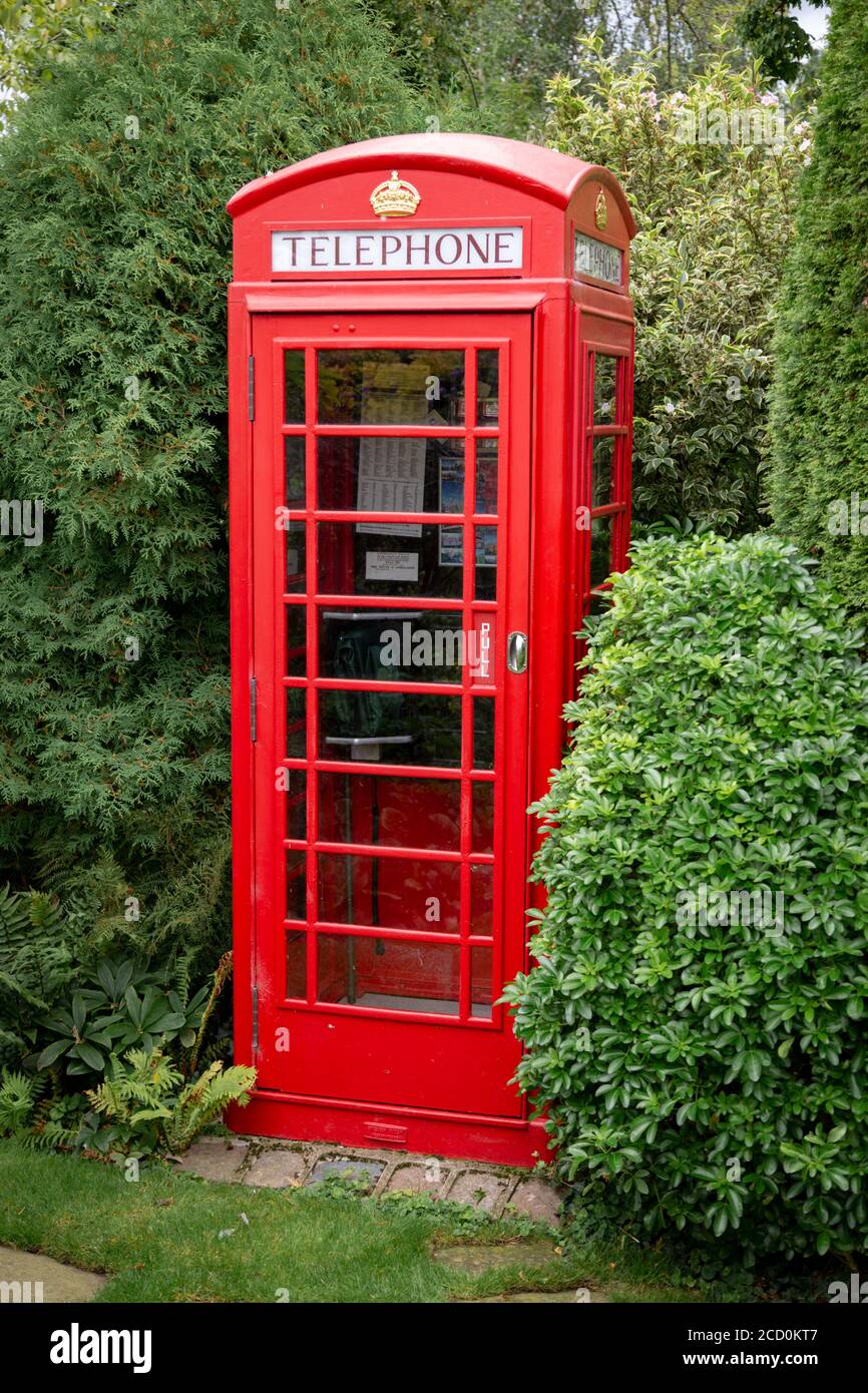 Red telephone box in a garden, UK Stock Photo - Alamy
