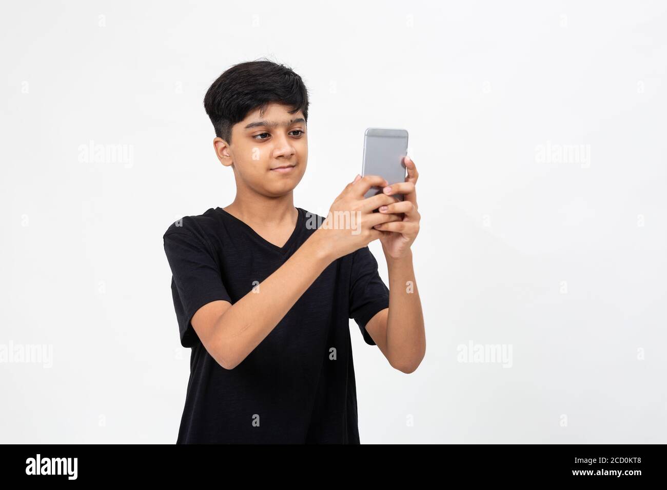Young Indian boy taking selfies on his mobile phone. Cute teenager ...